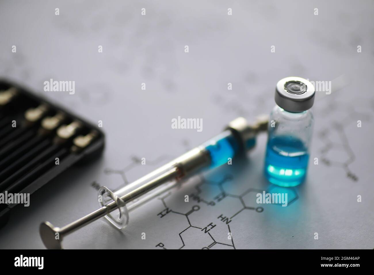 small jars with injection and syringe for injection on blue background ...
