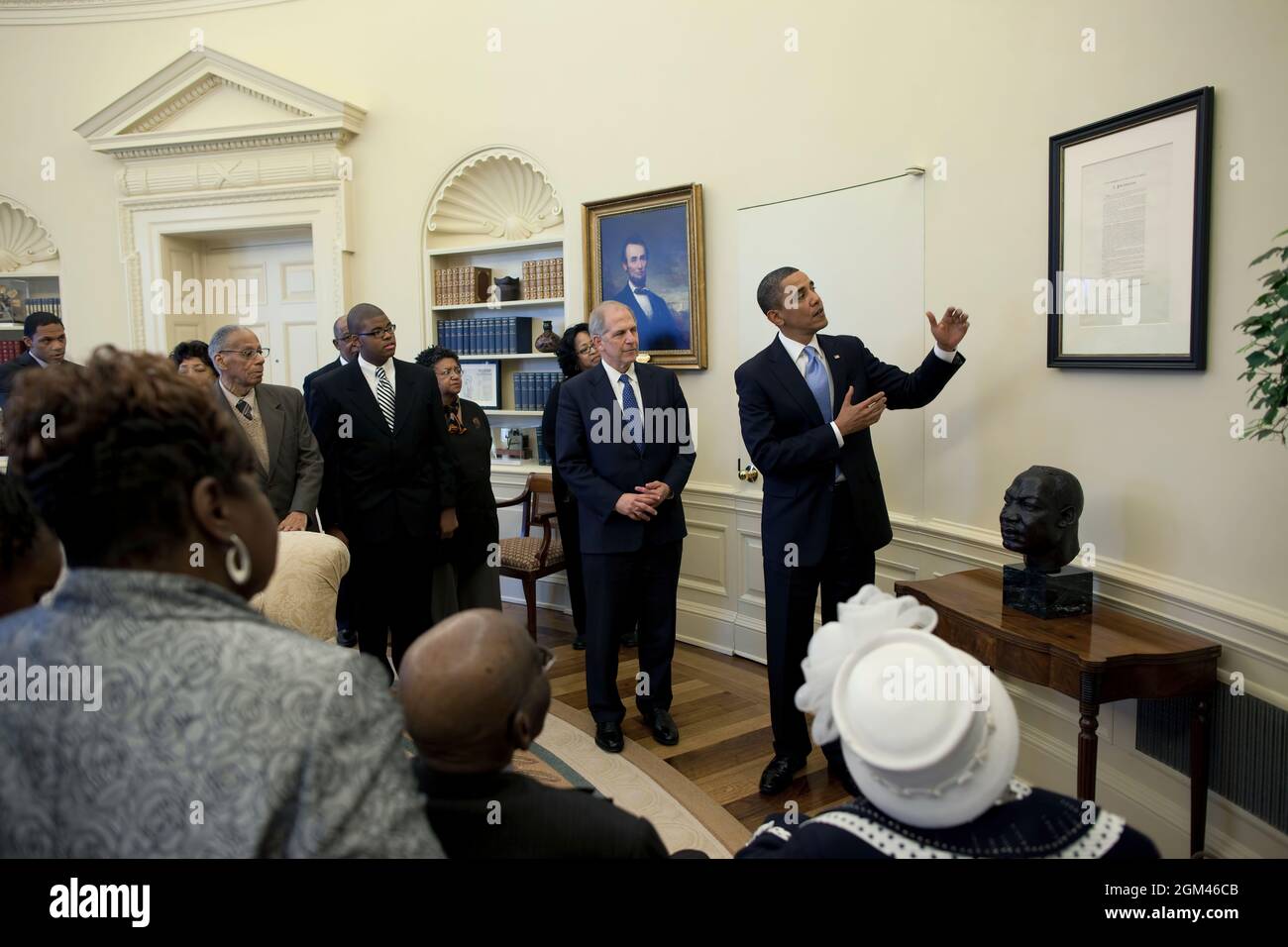 President Barack Obama and First Lady Michelle Obama meet with a small ...