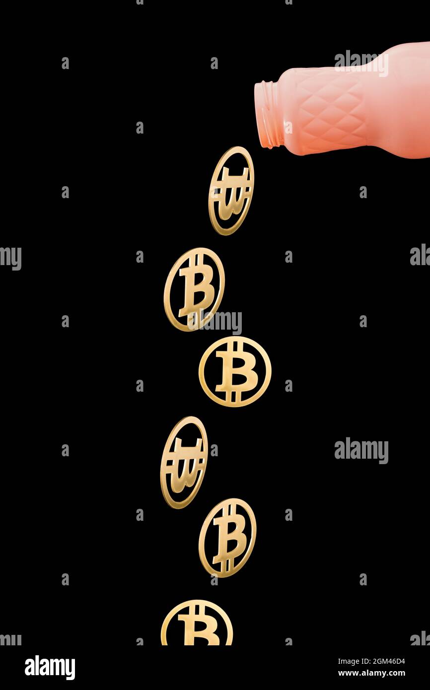 Bitcoins falling from the pink bottle against black background ...