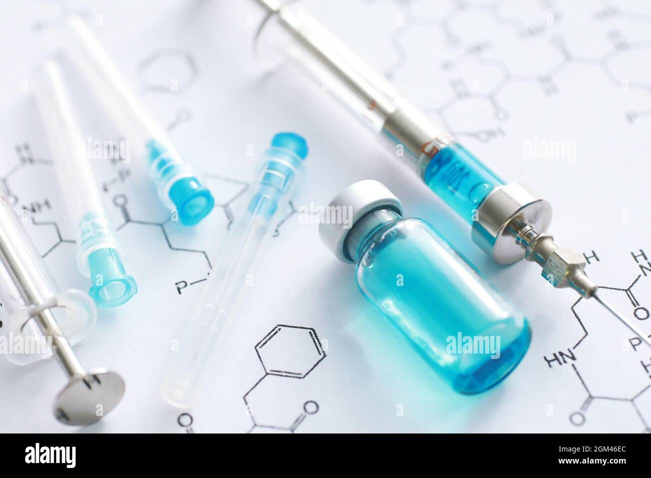 small jars with injection and syringe for injection on blue background ...