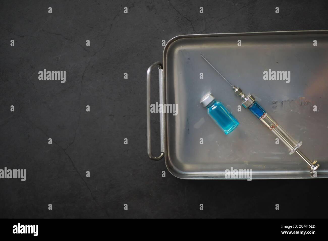 small jars with injection and syringe for injection on blue background ...