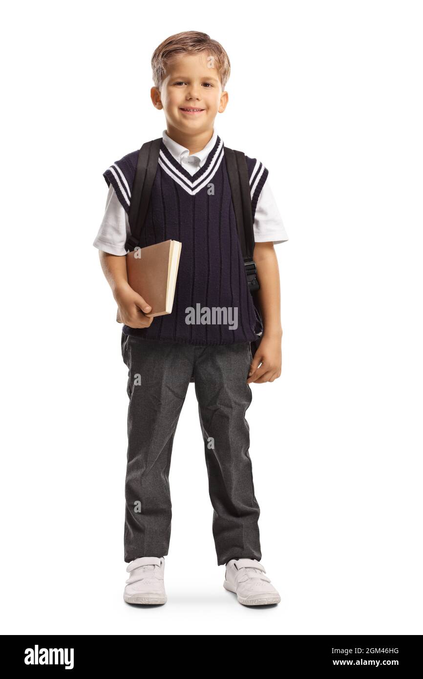 Full length portrait of a cute little schoolboy in a uniform holding a ...