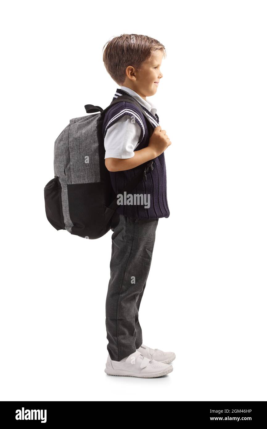 Full length profile shot of a cute little schoolboy in a uniform ...