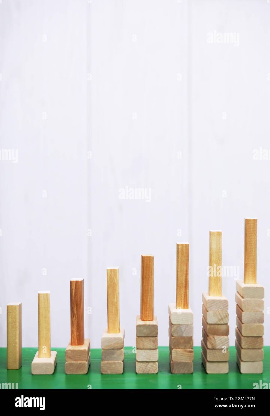 Stick wood block standing on stacked square wood blocks, abstract ...
