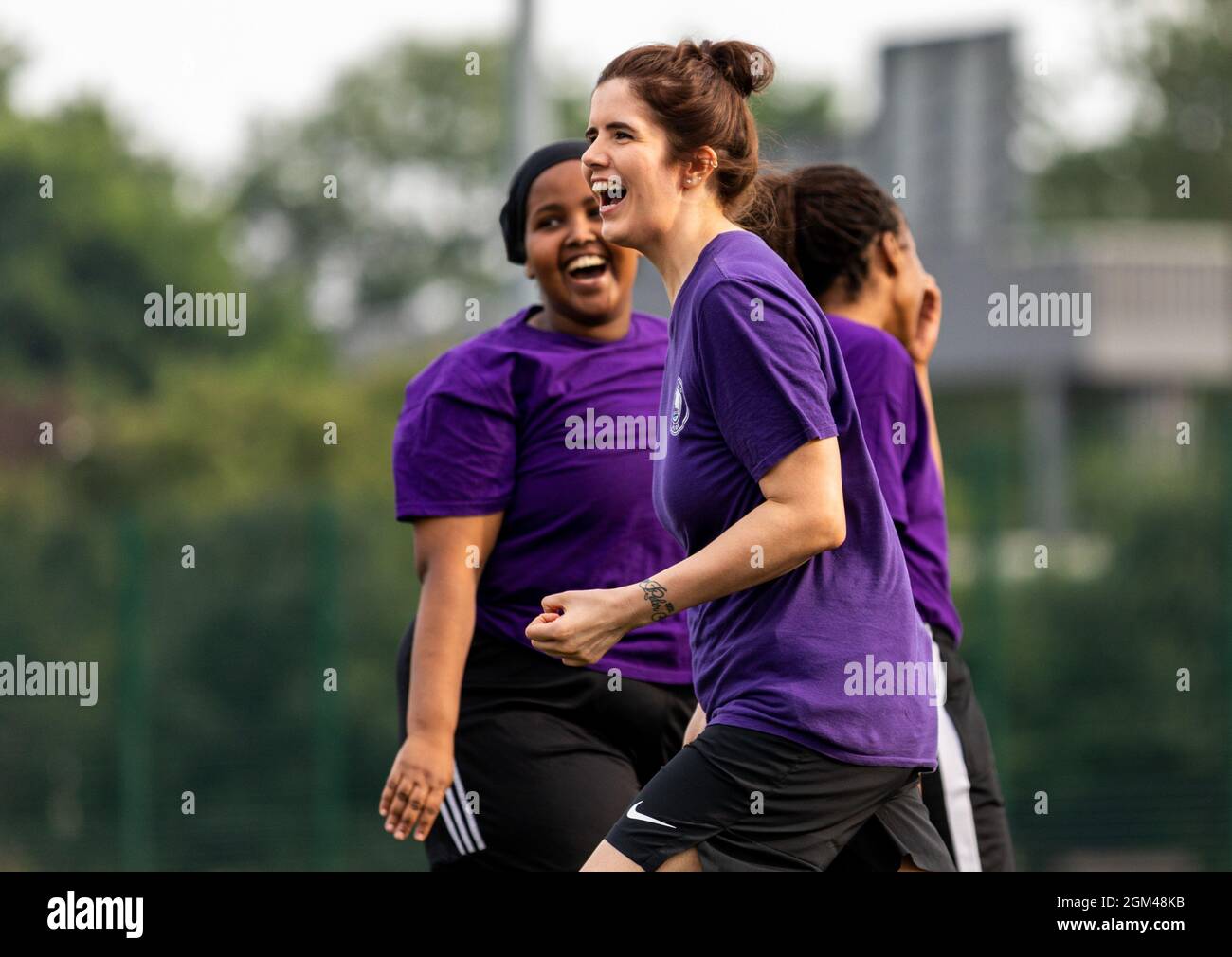 Grassroots female footballers smiling Stock Photo - Alamy