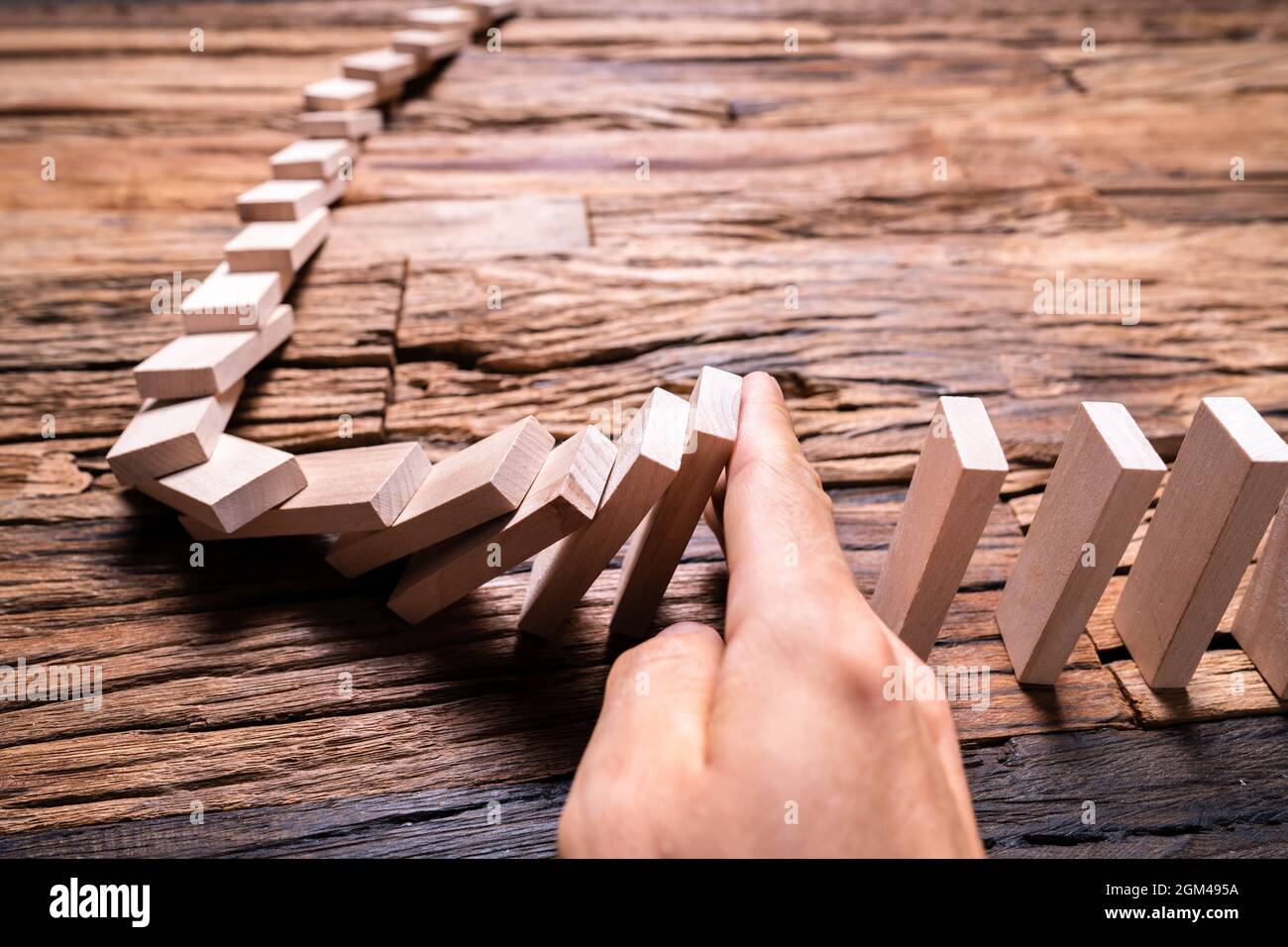 Domino Fall Prevention And Stop Using Hand Stock Photo - Alamy