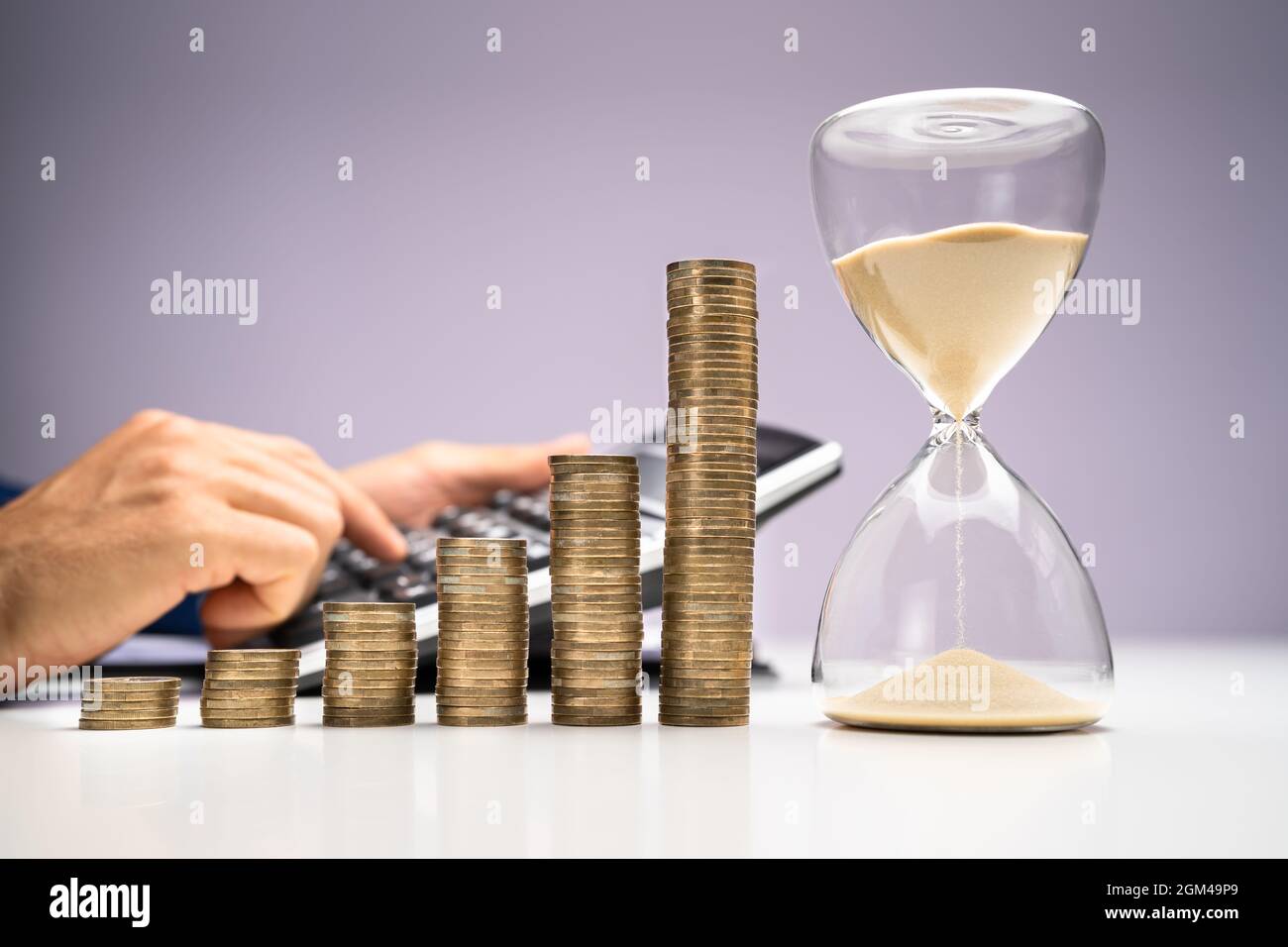 Increasing Money Coin Stack Concept. Hourglass And Time Stock Photo - Alamy