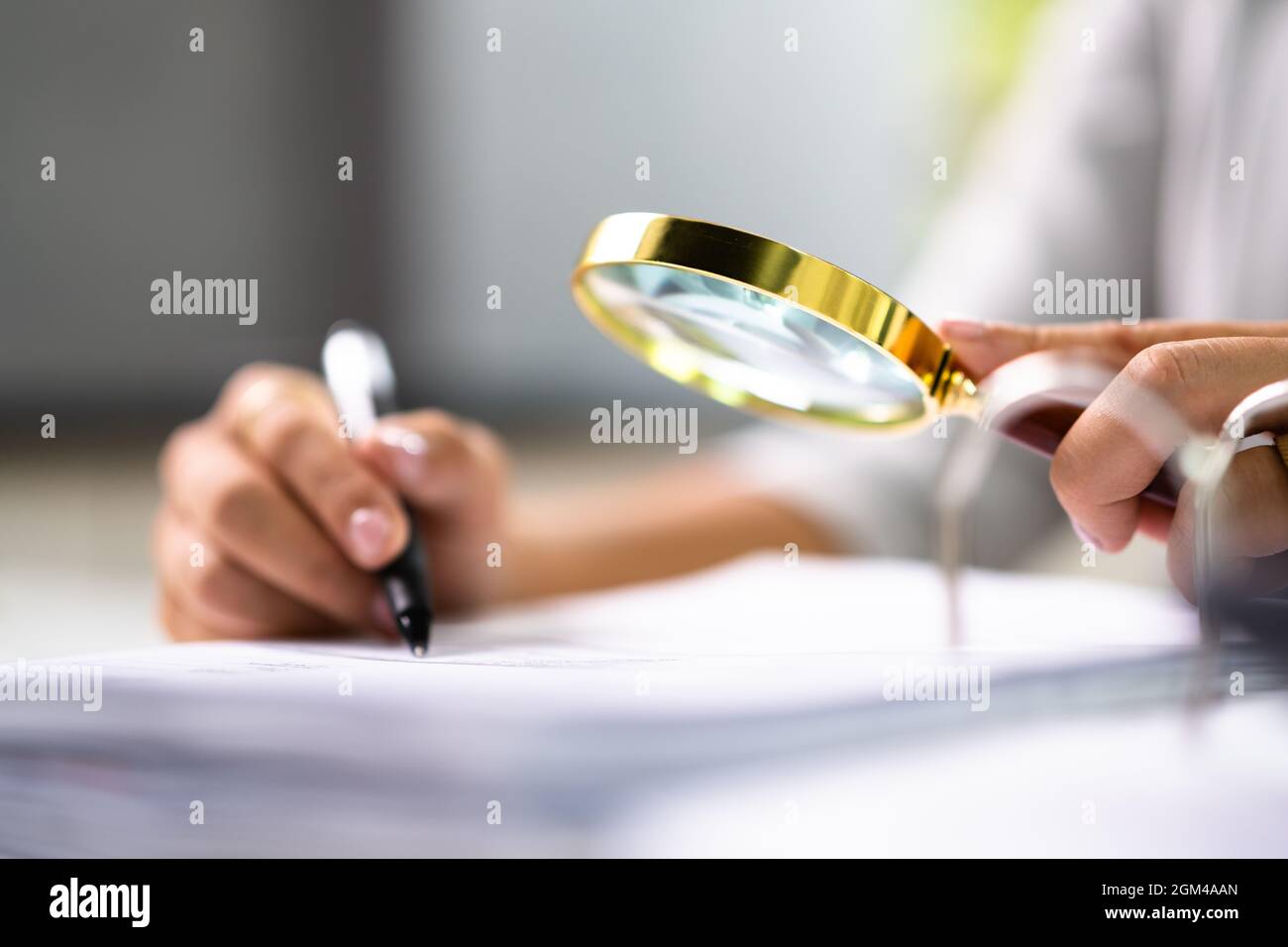 Auditor Doing Financial Audit And Tax Fraud Inspection Using Magnifying ...