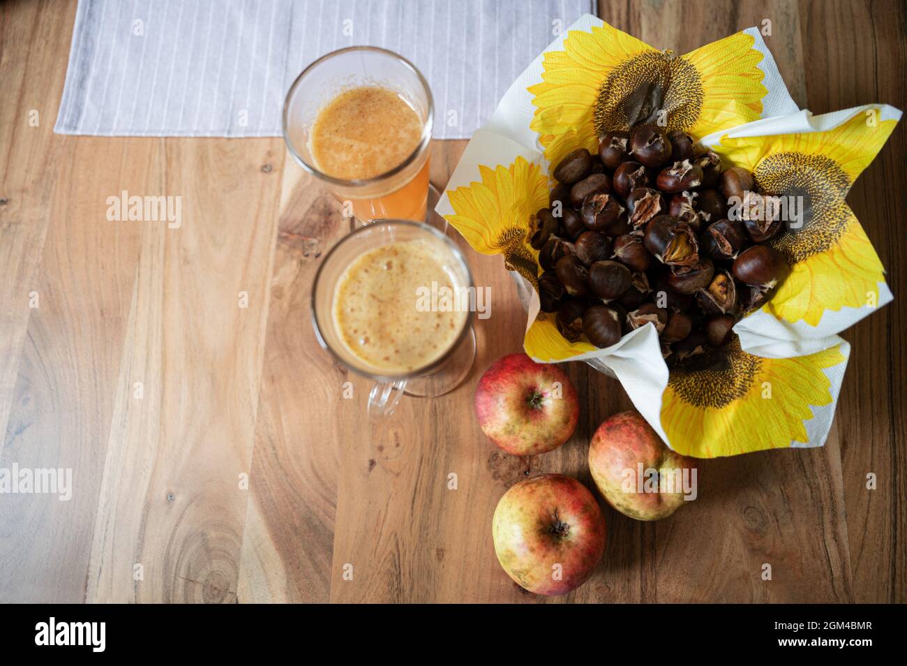 Top view of fall themed still life with roasted chestnuts, apples and ...