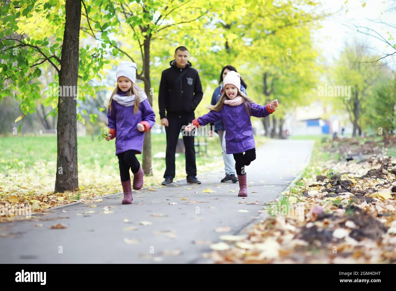 Children for a walk in autumn park. Leaf fall in the park. Family. Fall ...