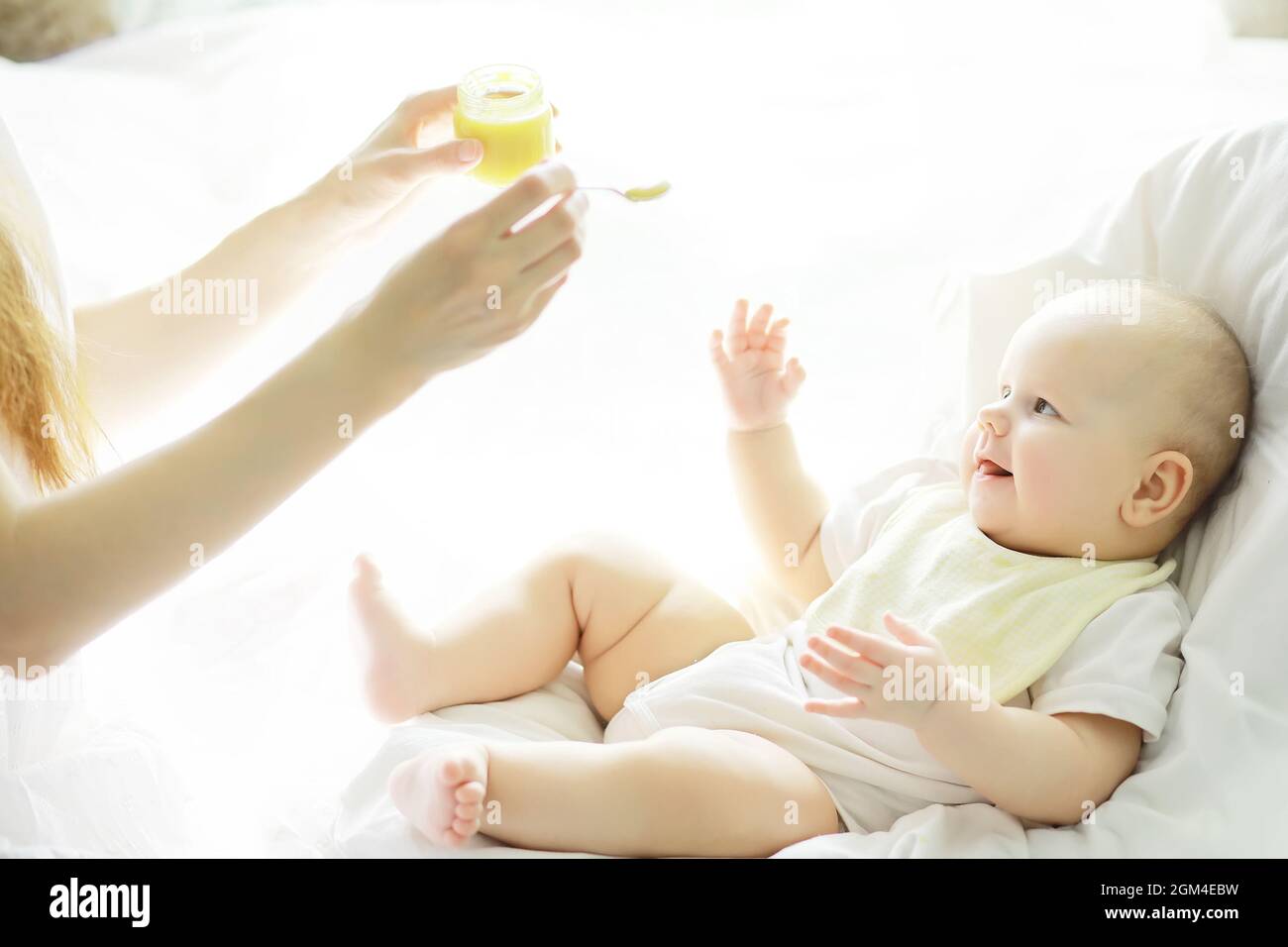 Maternity concept. A young mother feeds her little baby. First lure and ...