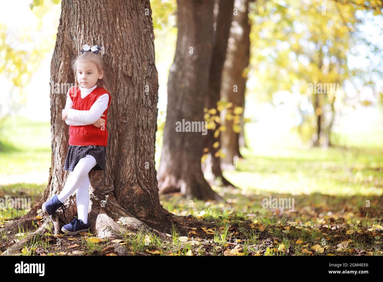 Children with briefcases for a walk in park. School break. The ...