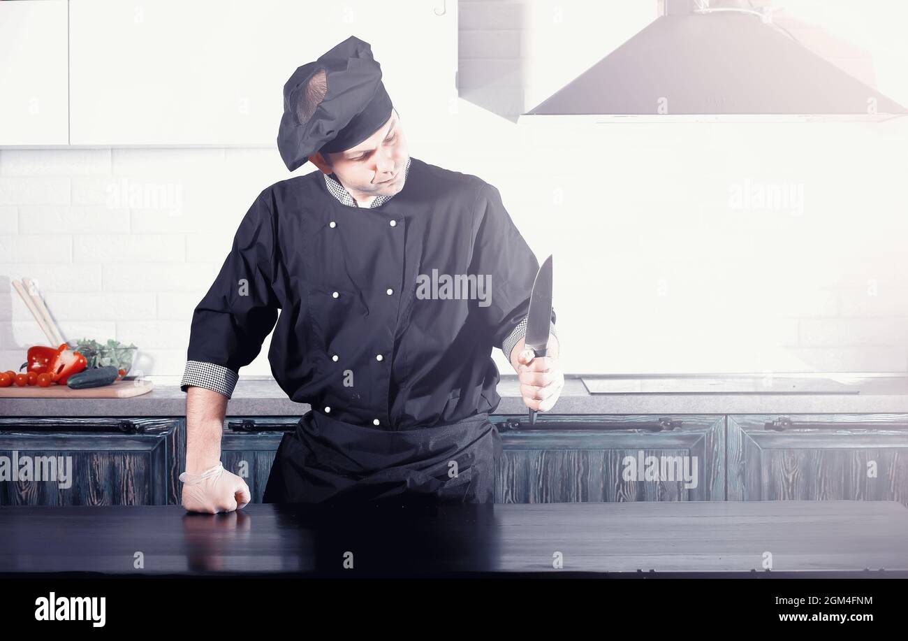 Man cook preparing food at the kitchen table of vegetables Stock Photo ...