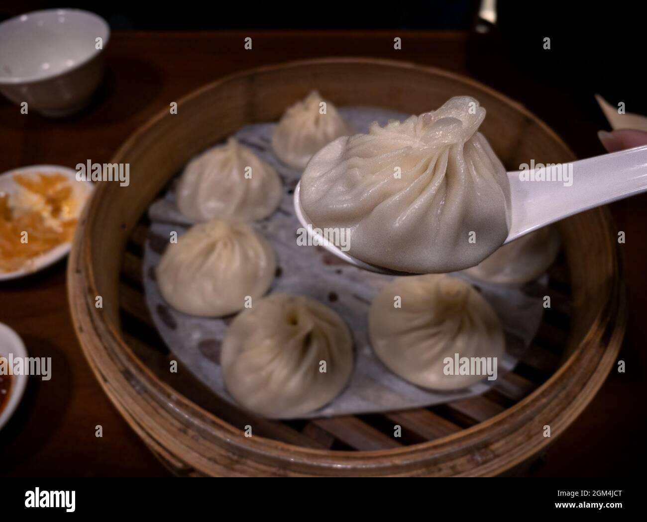 Dipping dumpling in asian restaurant. Eat the traditional chinese food ...