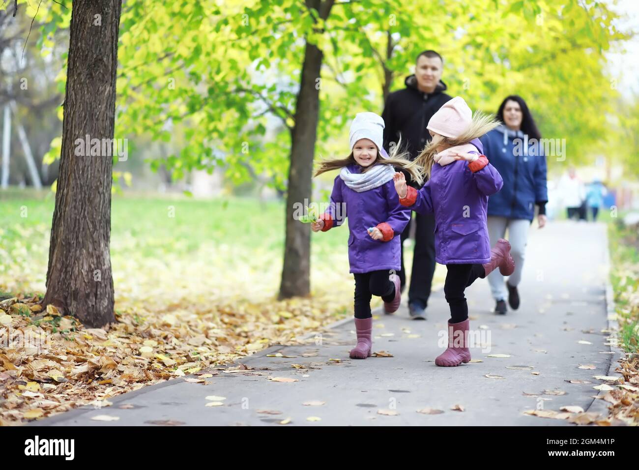Children for a walk in autumn park. Leaf fall in the park. Family. Fall ...