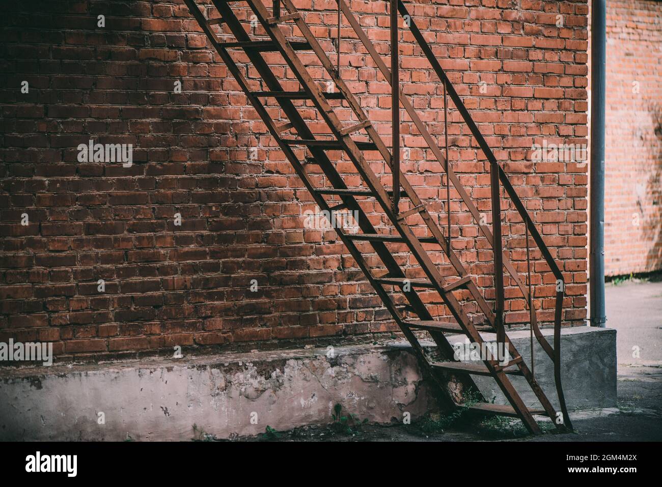 old vintage bulding with rustic metallic ladder at brick wall Stock ...
