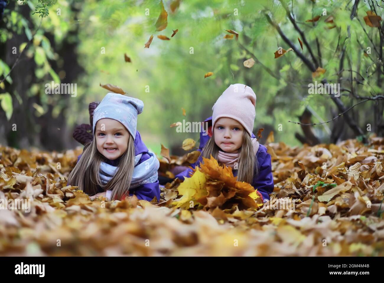 Children for a walk in autumn park. Leaf fall in the park. Family. Fall ...