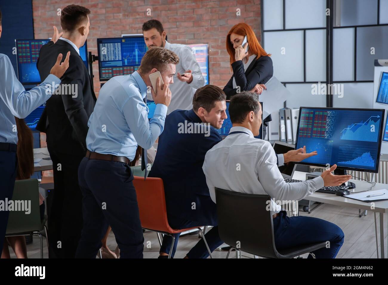 Stock traders working in office Stock Photo - Alamy