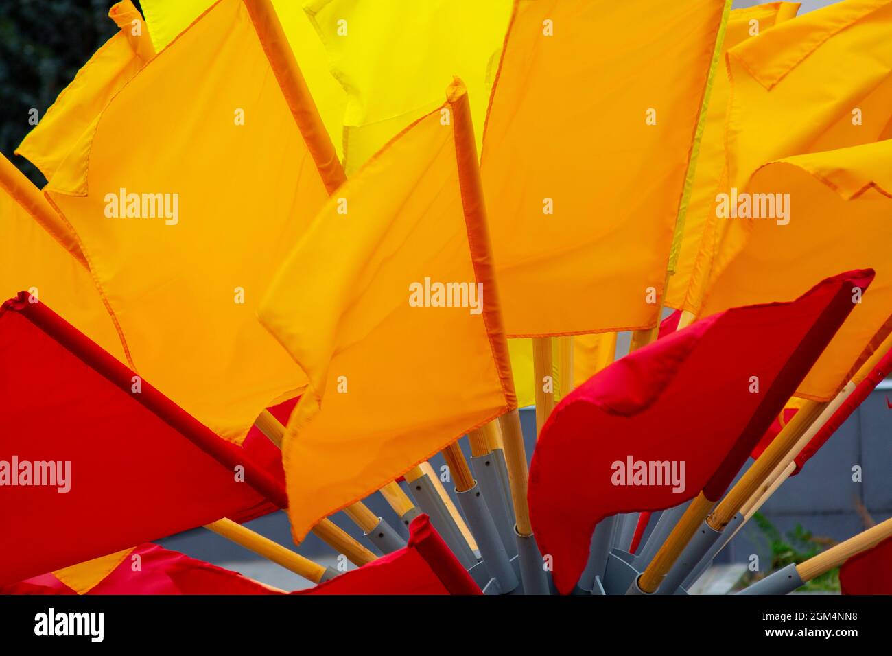 Red and yellow textile flags with natural background fluttering in the ...