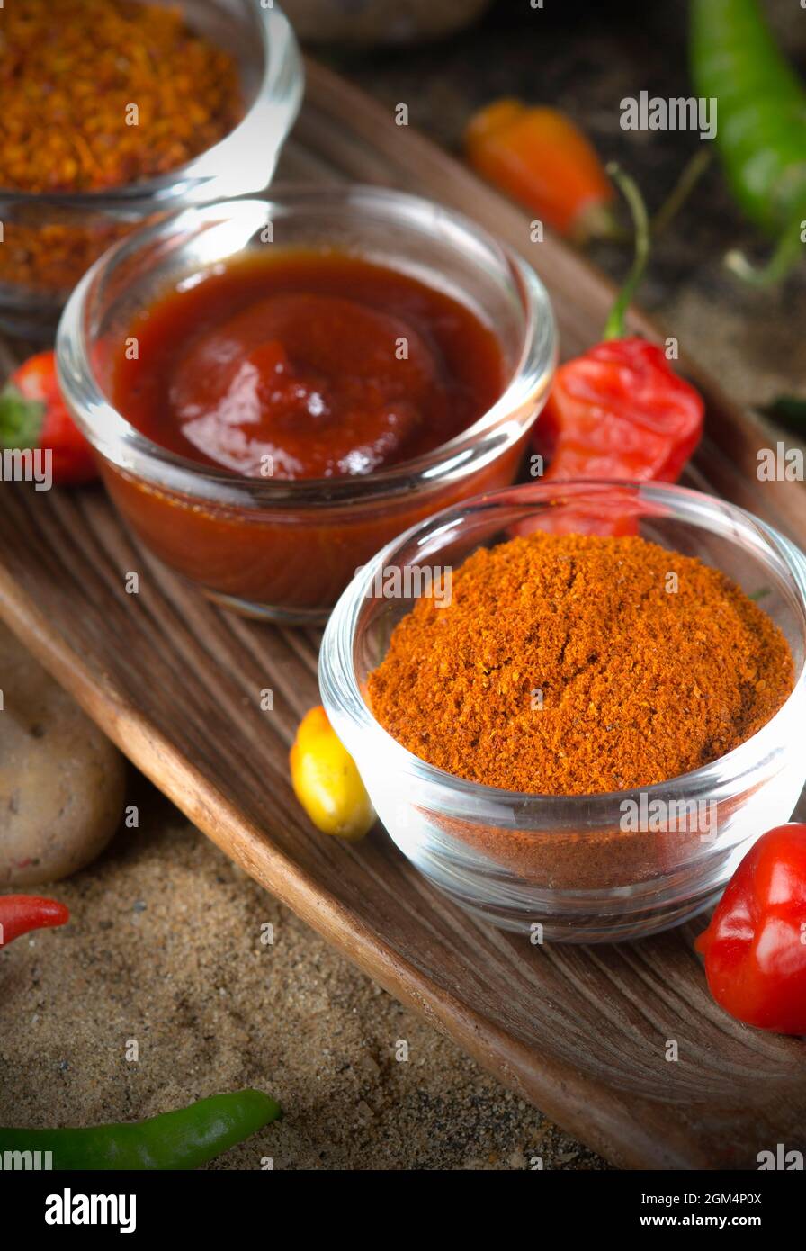 Chilli in powder, sauce, and piece in a glass bowl. Close up with a ...