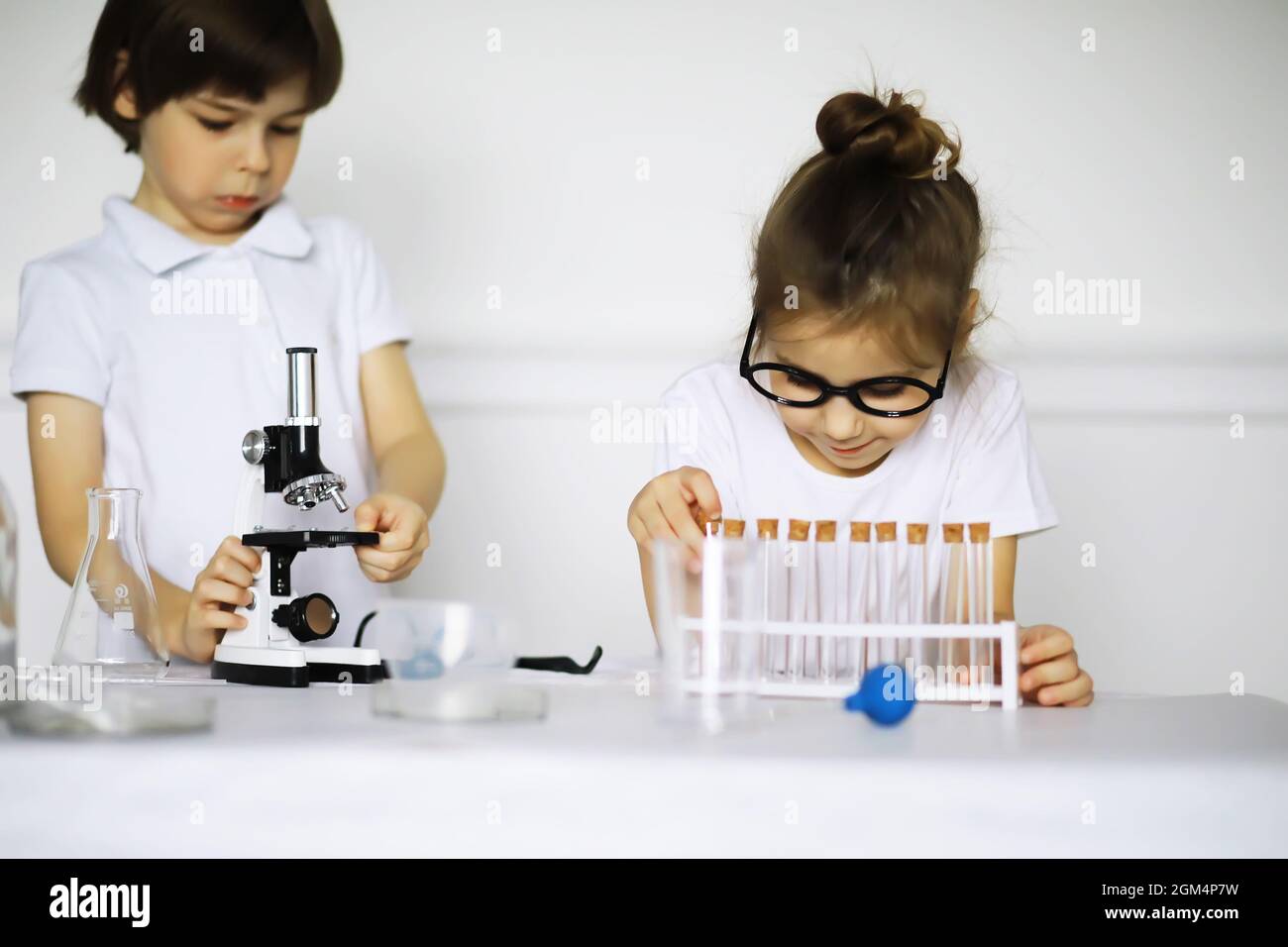 Two cute children at chemistry lesson making experiments isolated on ...