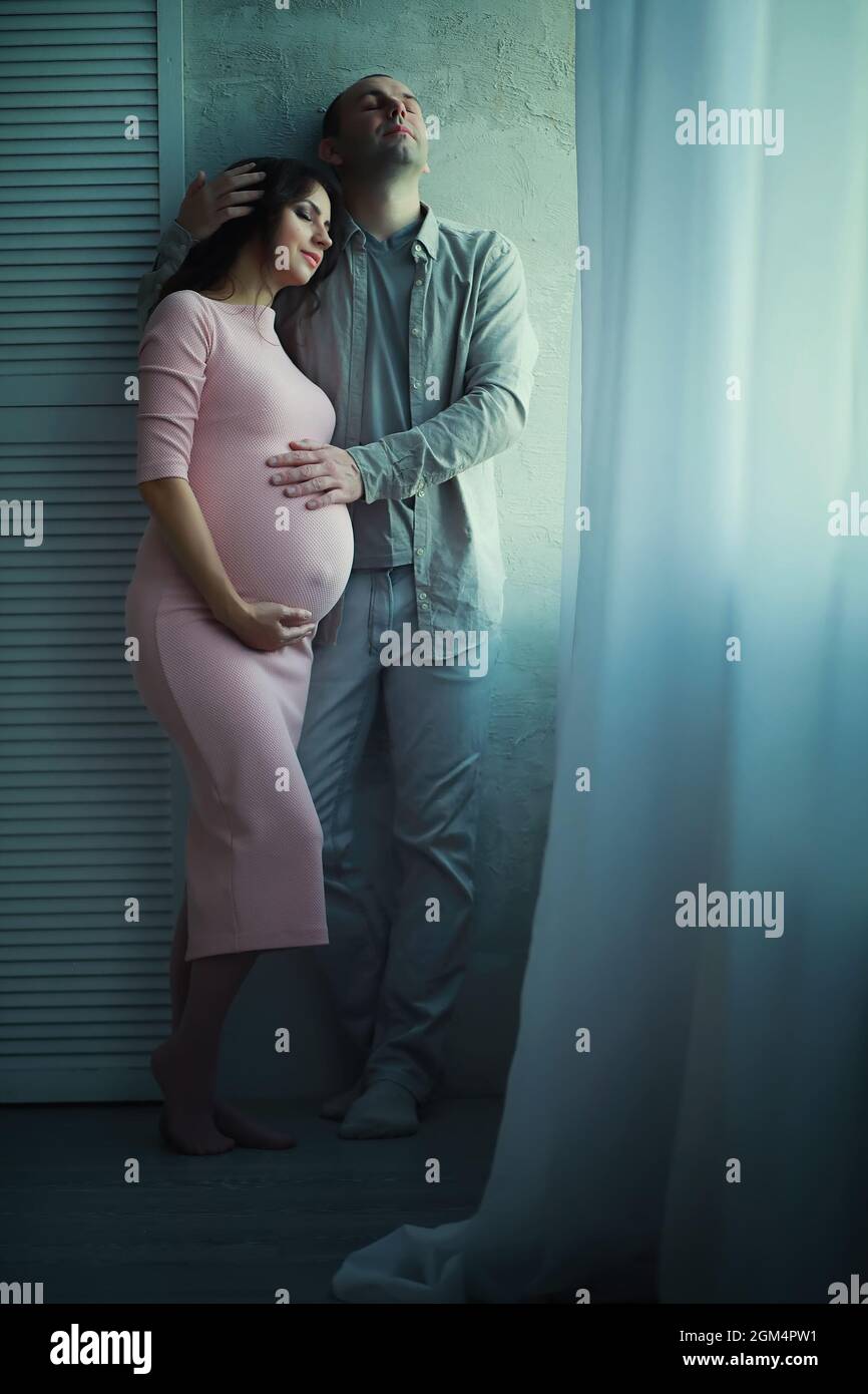 Beautiful pregnant girl with a big belly. Young married pregnant couple ...
