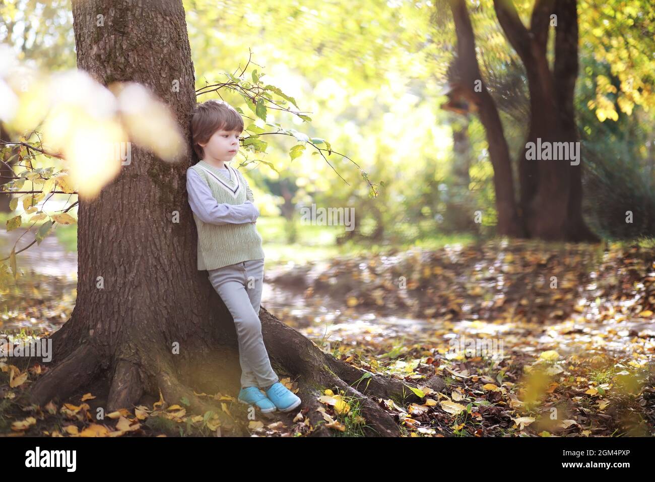 Children with briefcases for a walk in park. School break. The ...