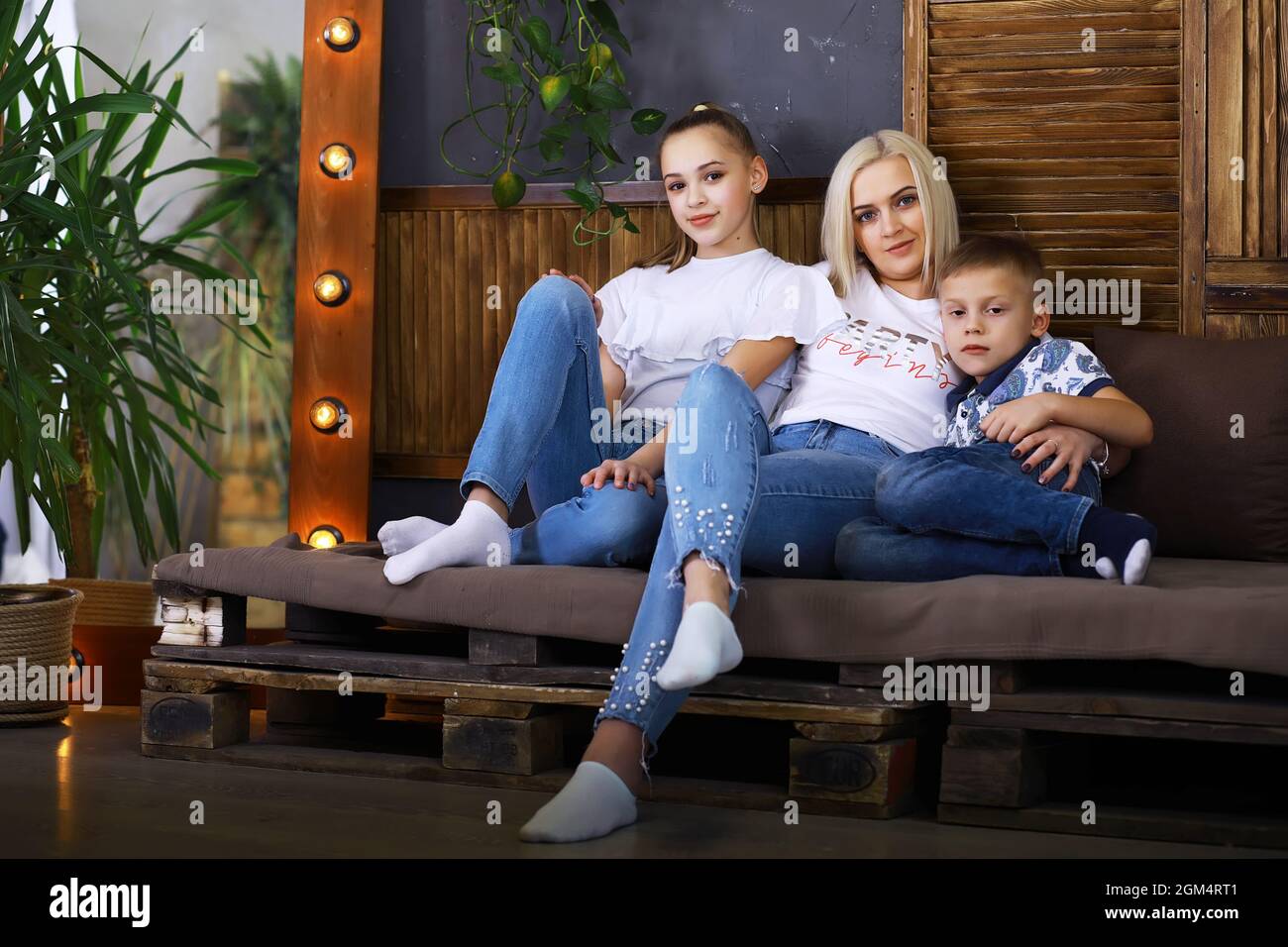 Funny active family of young adult parents and cute small children ...