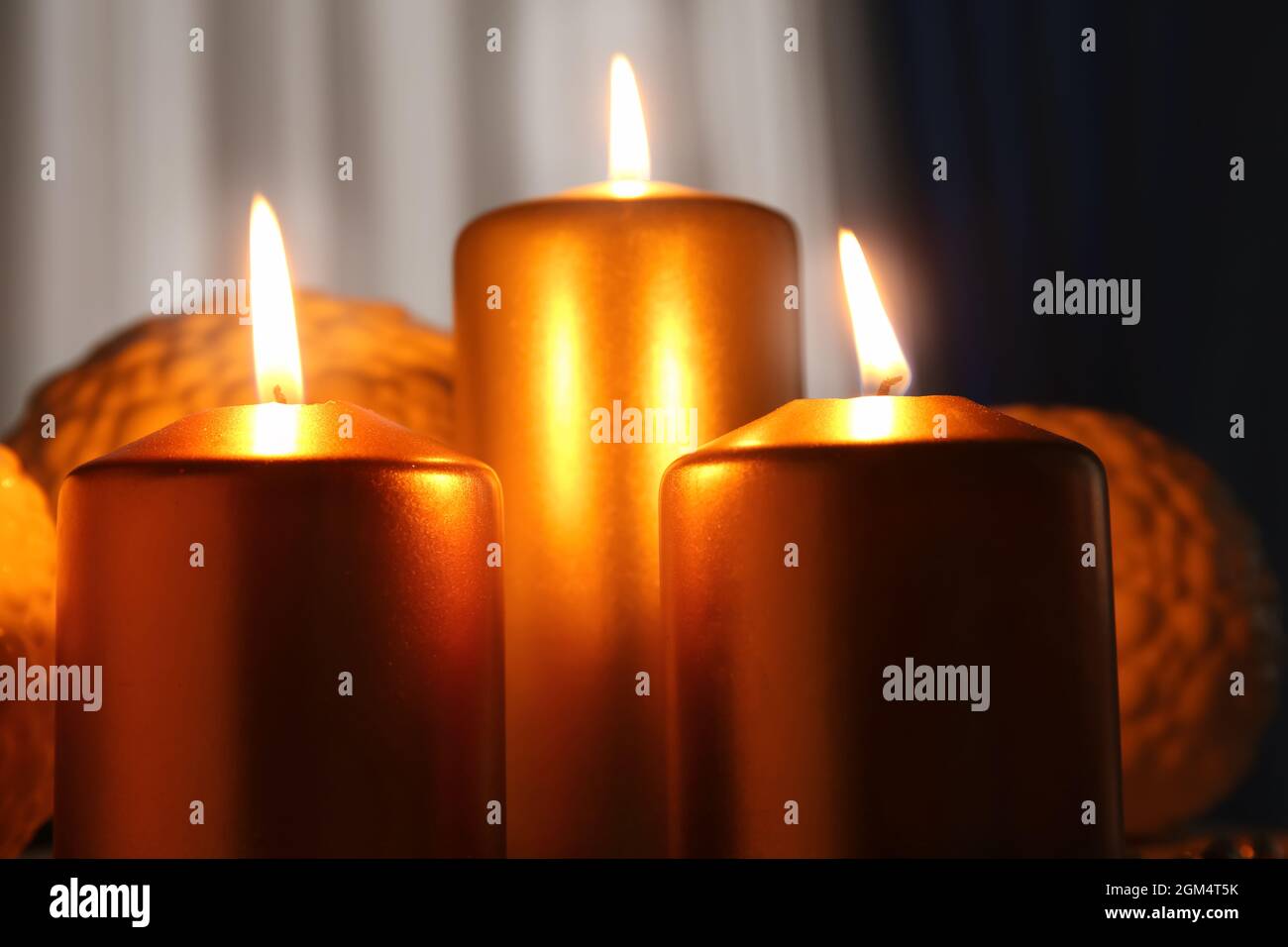 Metallic pillar candles burning on blurred background, closeup Stock ...