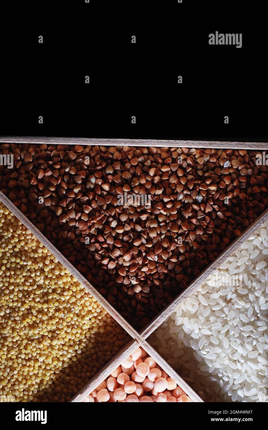 A set of grain cereals. Rice, buckwheat and millet groats in wooden ...