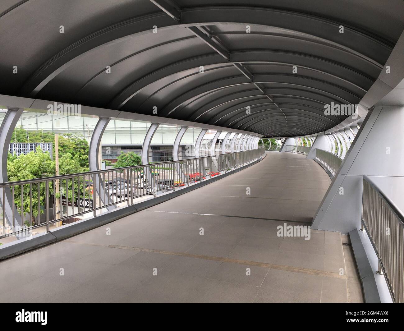 Modern overhead pedestrian crossing with a covered roof Stock Photo - Alamy