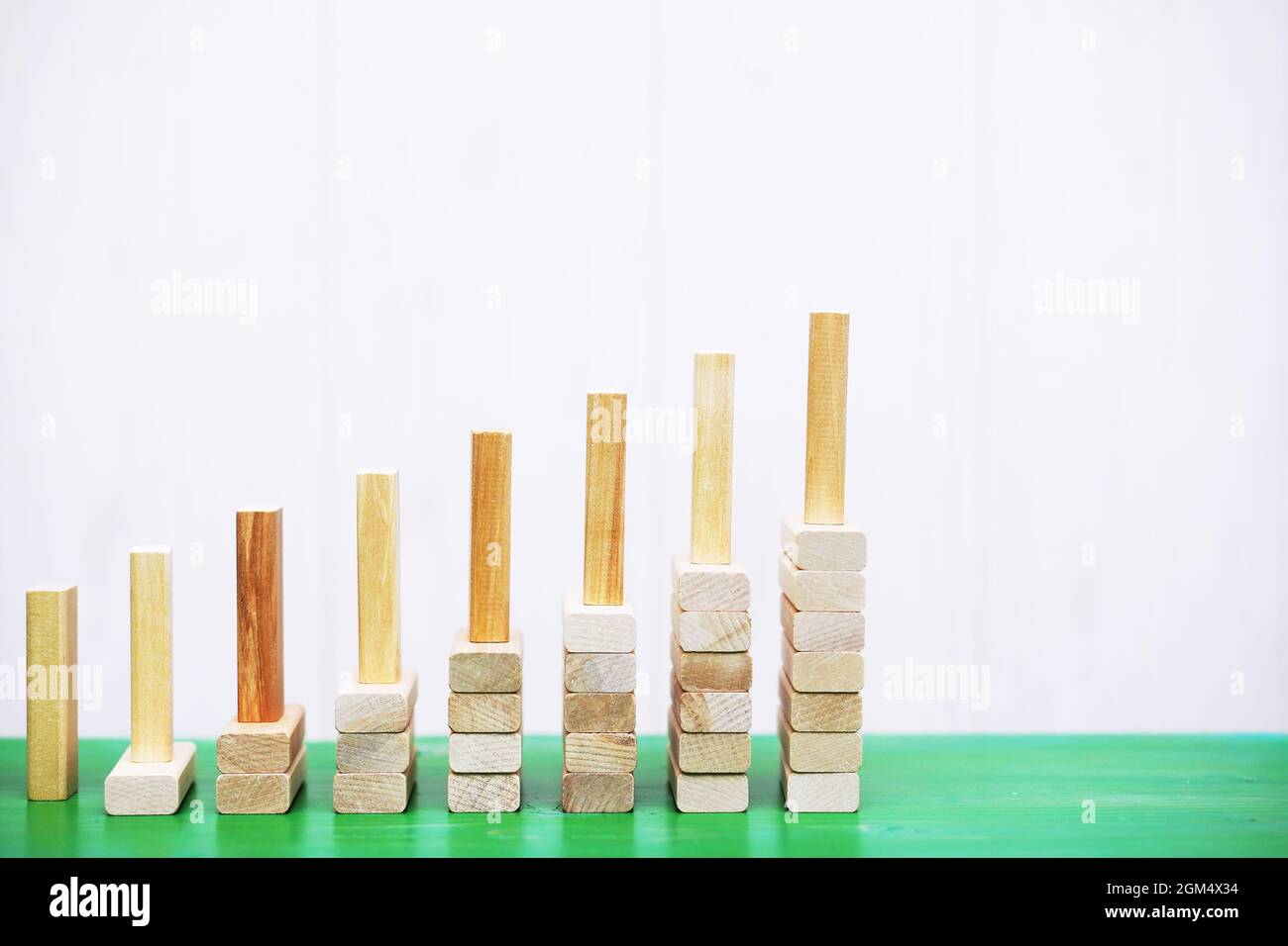 Stick wood block standing on stacked square wood blocks, abstract ...
