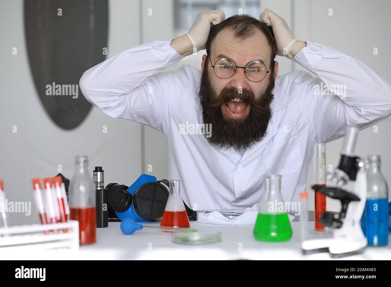 Chemist crazy. A mad scientist conducts experiments in scientific ...