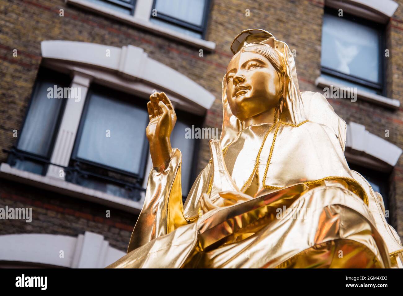 Chinese New Year celebration parade with gold woman statue holding ...