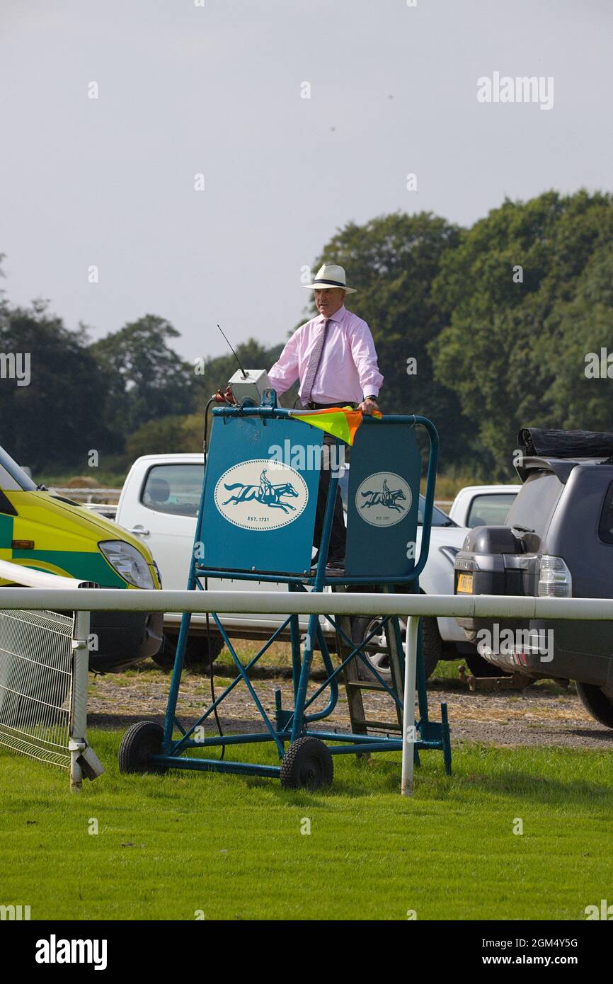 The starting official standing ready to press the button to start a ...