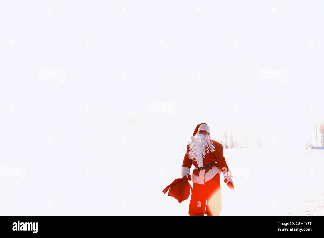 Santa in the winter field. Santa magical fog walking along the field ...