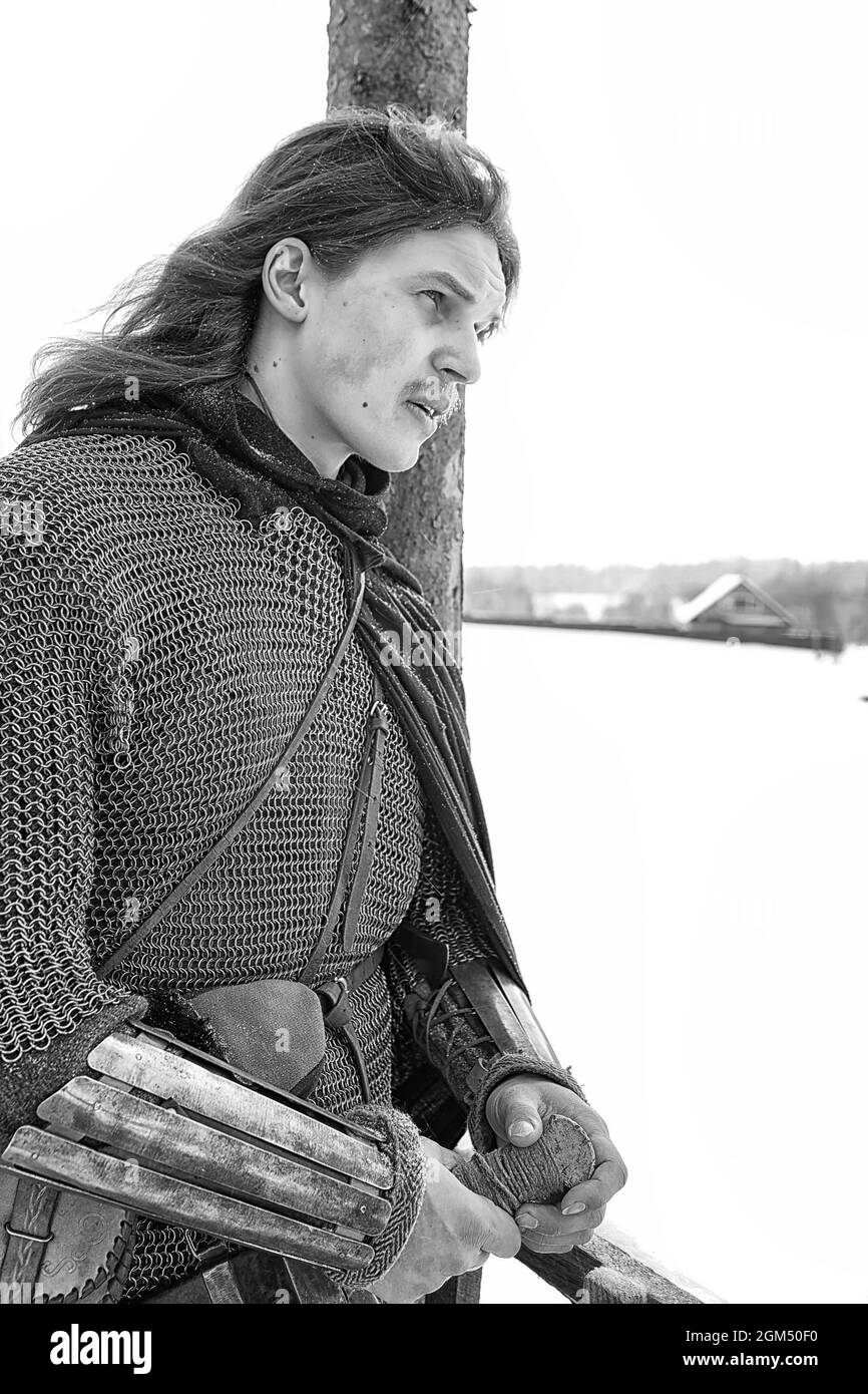 Defender the young warrior in mail armor armed with a sword and an ax ...