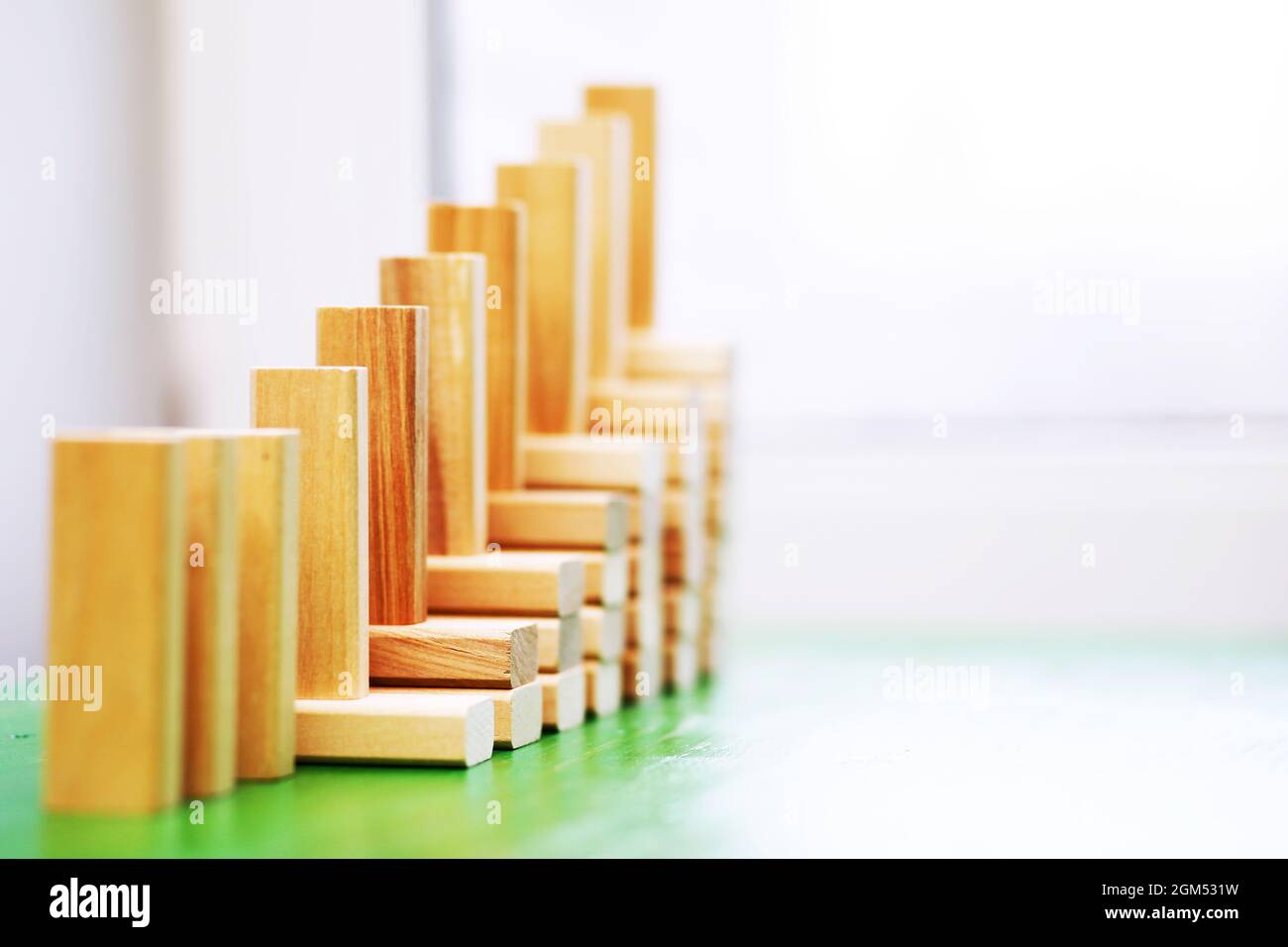 Stick wood block standing on stacked square wood blocks, abstract ...