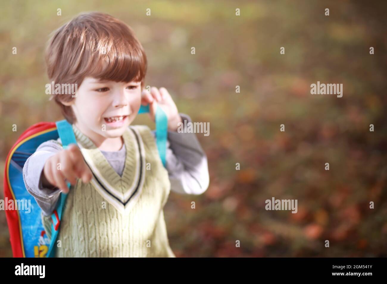 Children with briefcases for a walk in park. School break. The ...