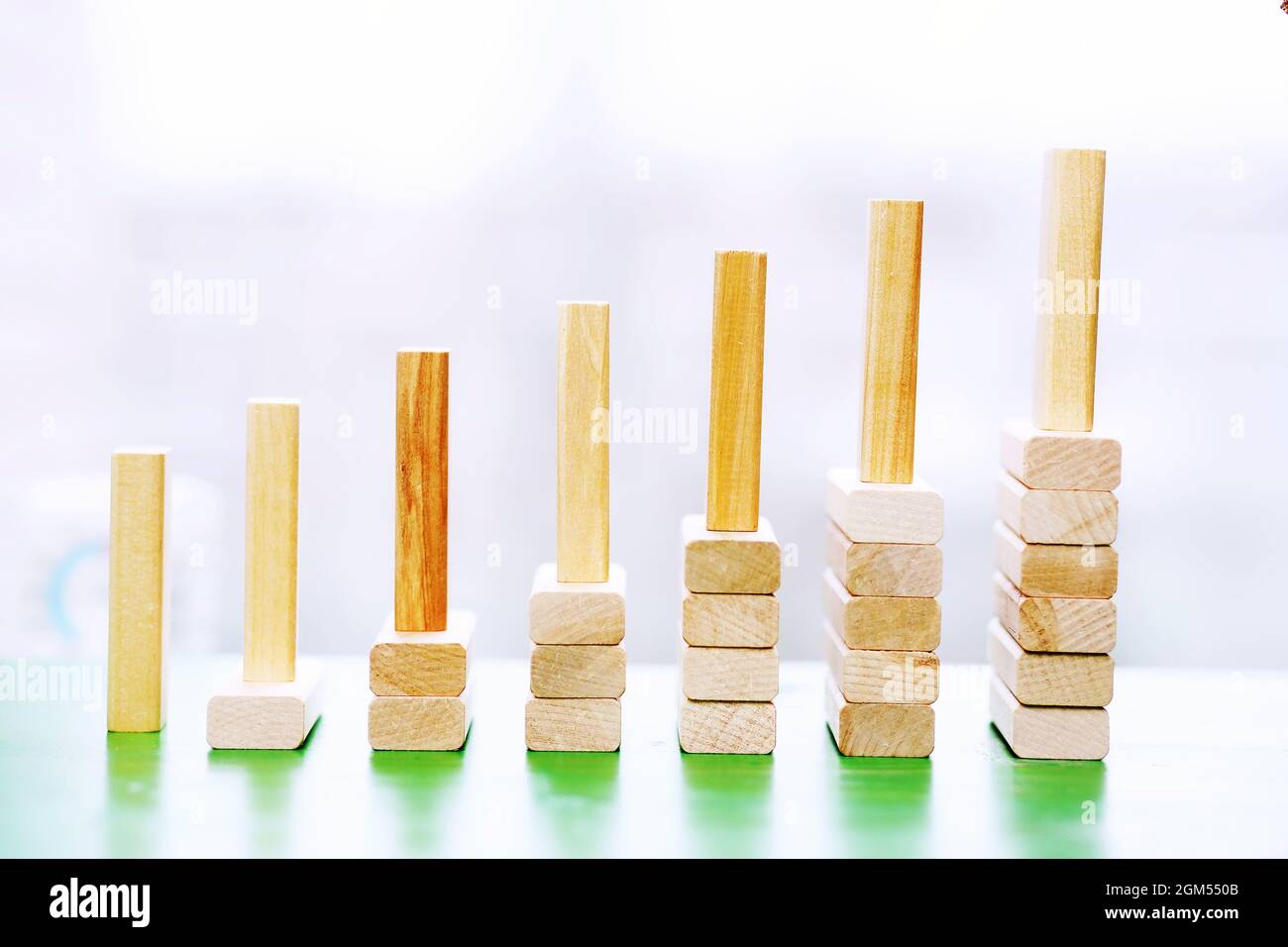 Stick wood block standing on stacked square wood blocks, abstract ...