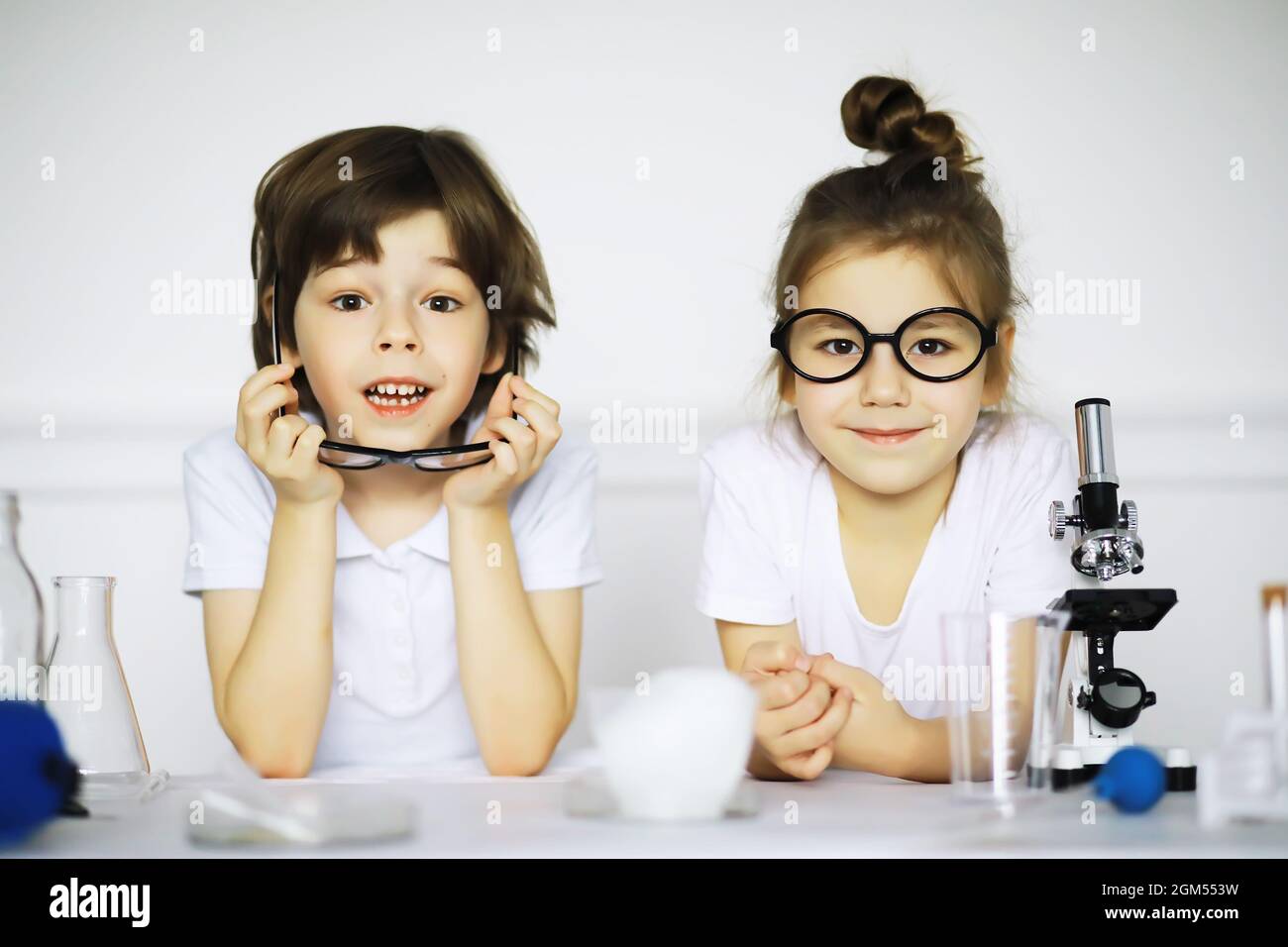Two cute children at chemistry lesson making experiments isolated on ...