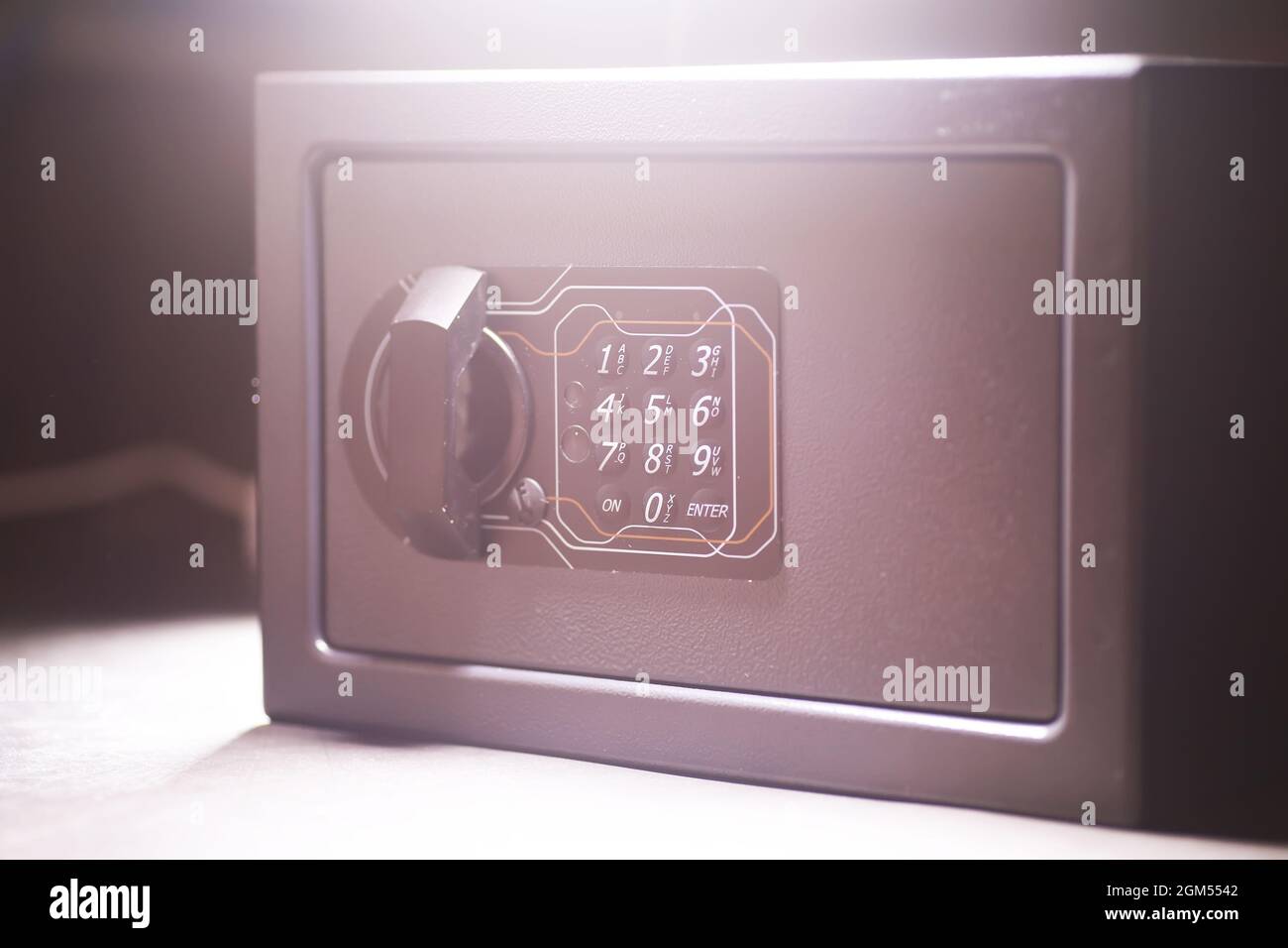 Steel safe with money. Hand putting password in the safety money box in ...