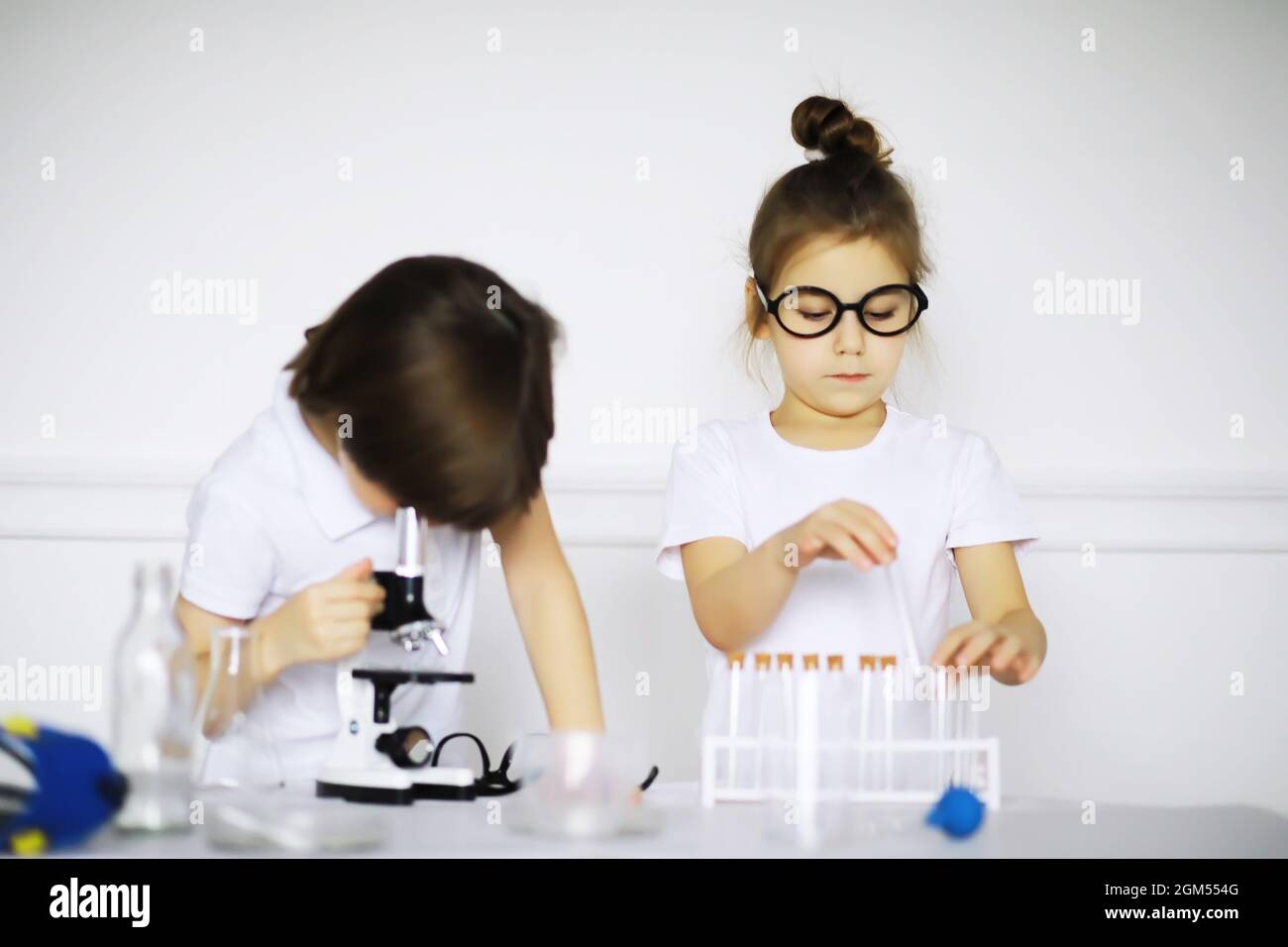 Two cute children at chemistry lesson making experiments isolated on ...