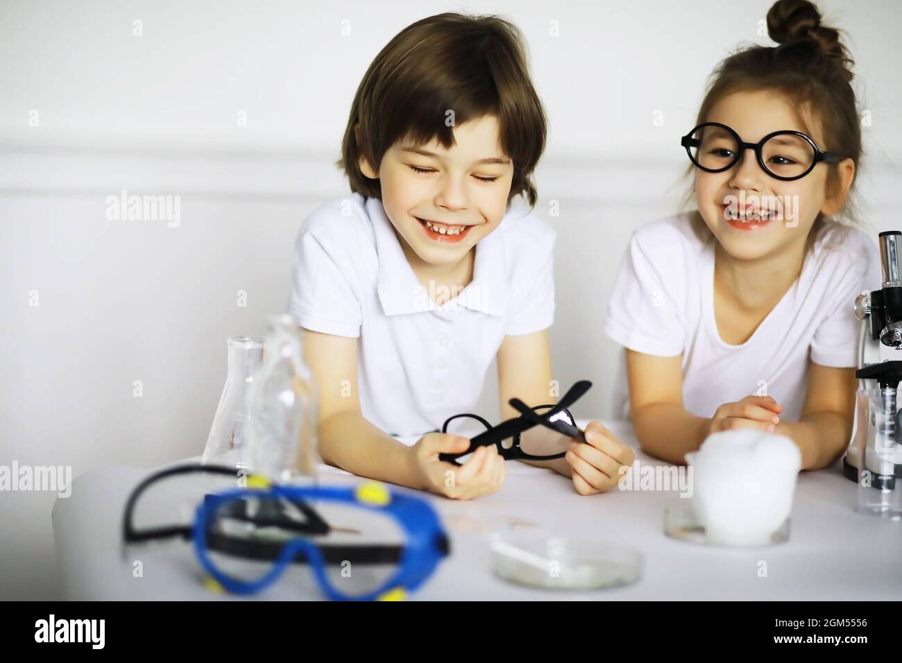 Two cute children at chemistry lesson making experiments isolated on ...