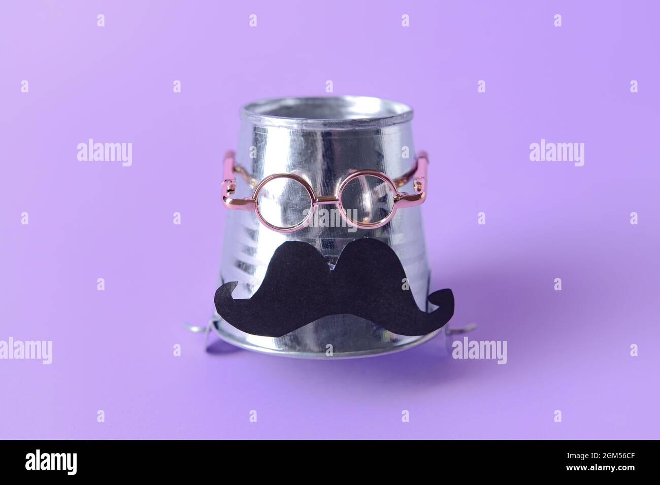 Funny bucket in eyeglasses and paper mustache on color background Stock ...