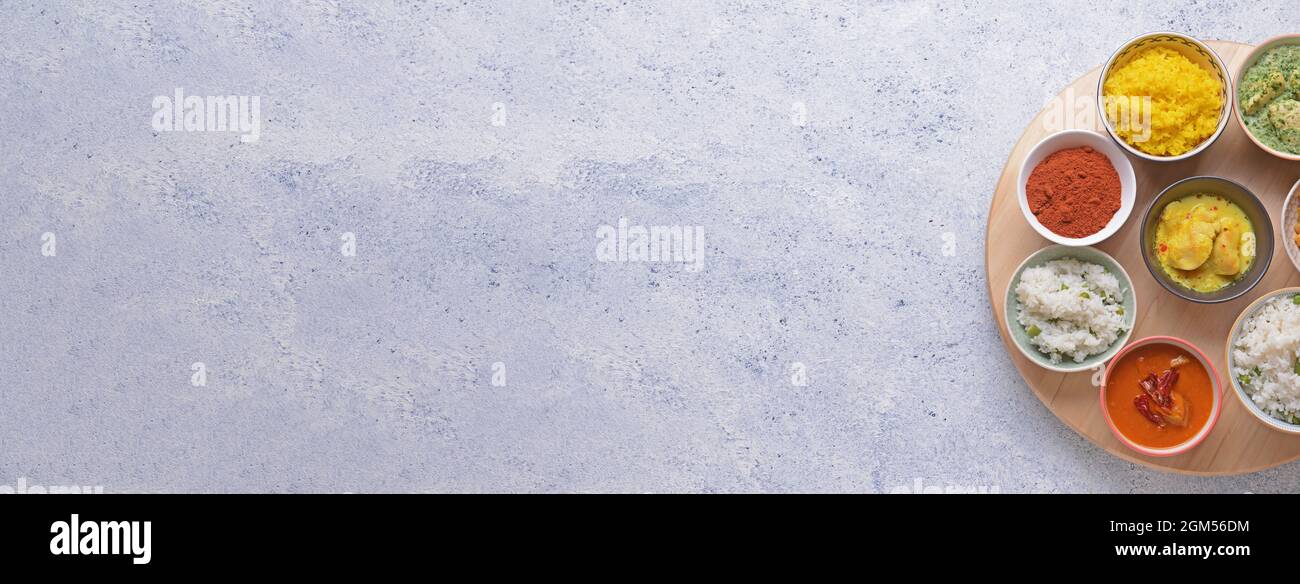 Board with traditional Indian food and spices on grunge background with ...