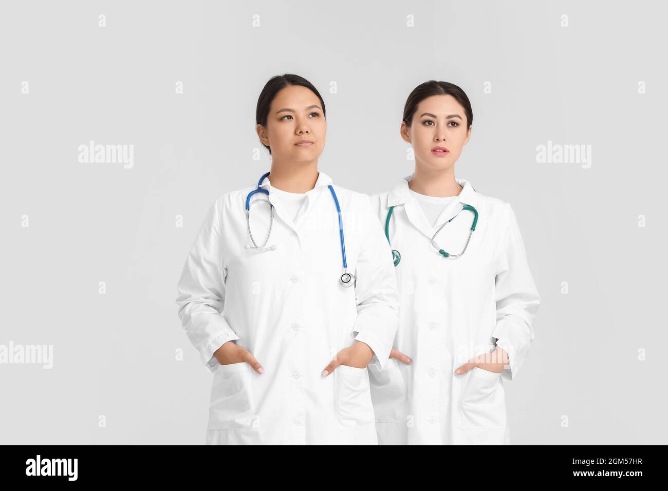Portrait of female Asian doctors on light background Stock Photo - Alamy