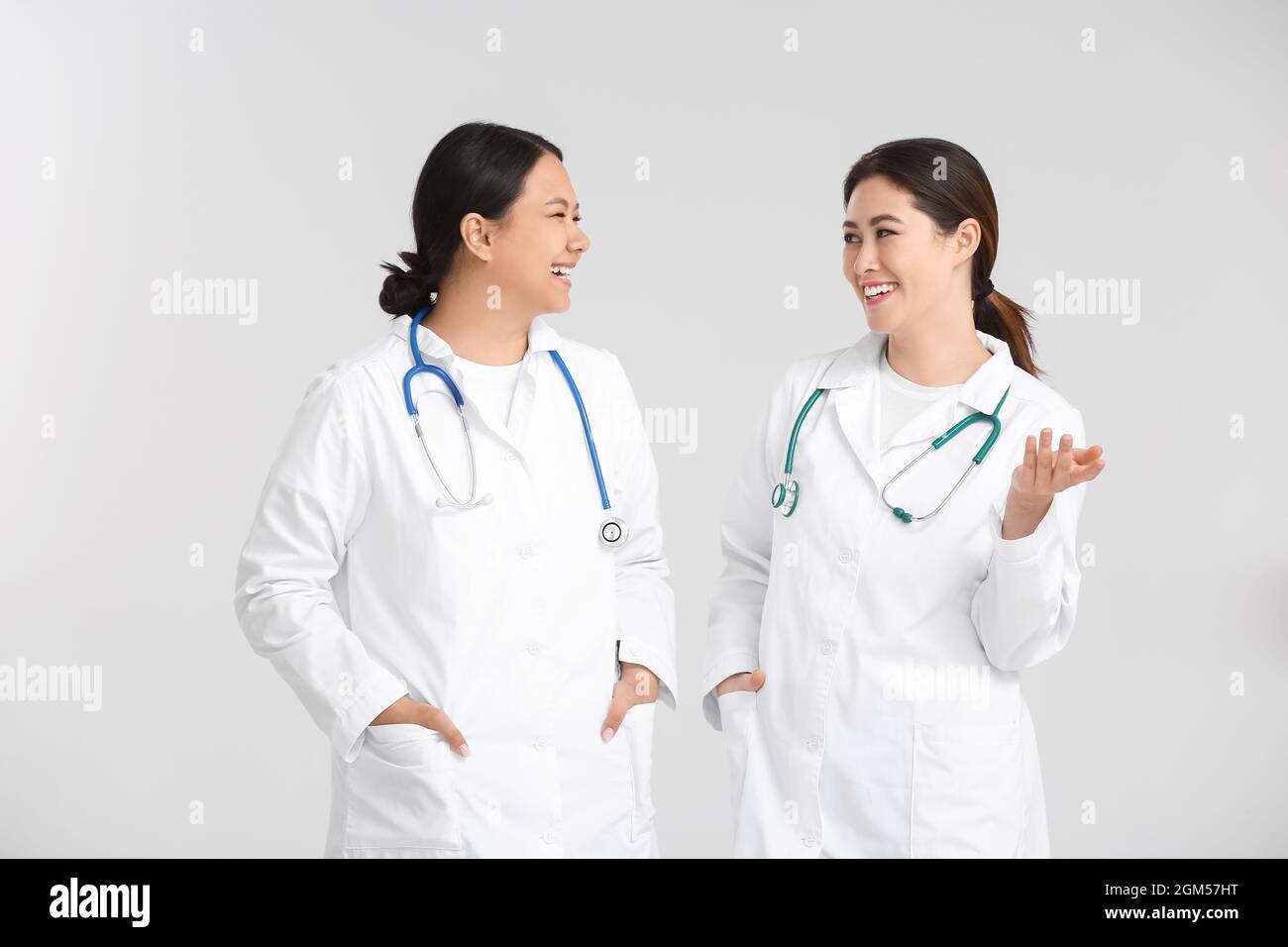 Portrait of female Asian doctors on light background Stock Photo - Alamy
