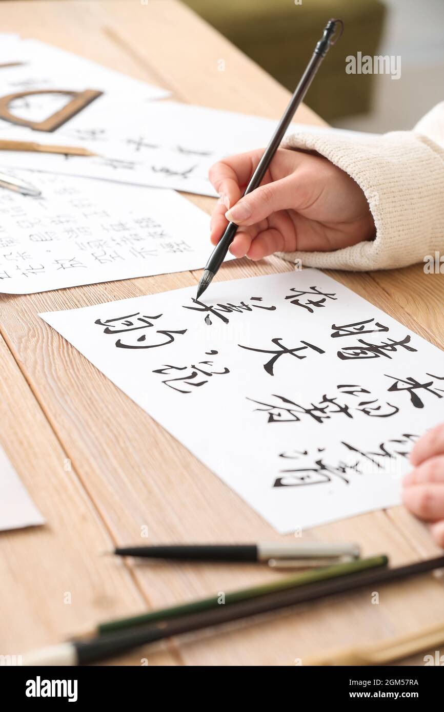 Female Asian calligraphist working in office, closeup Stock Photo - Alamy