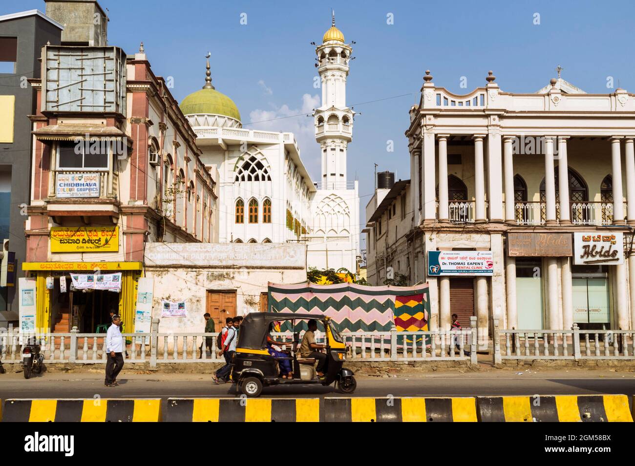 Mysore, Karnataka, India : An auto-rickshaw drives past a mosque at ...